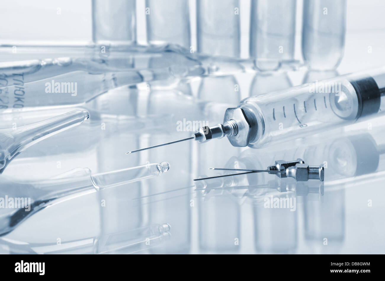 Vials and old glass syringe whis still needles Stock Photo - Alamy