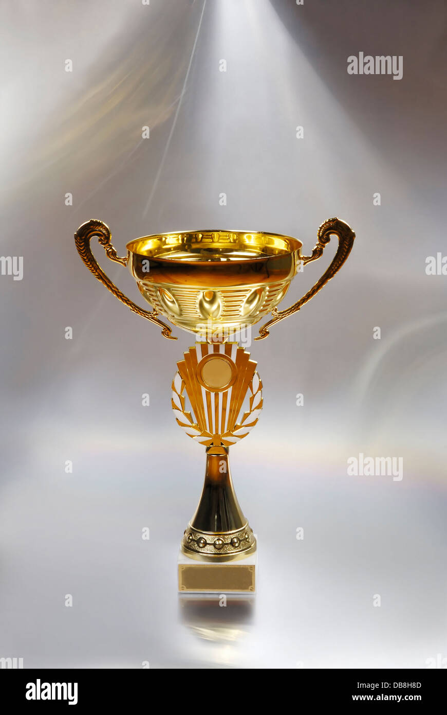 Large golden trophy on gray background Stock Photo - Alamy
