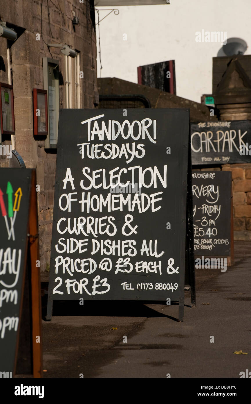 Blackboard outside a pub advertising special food offers in the UK ...