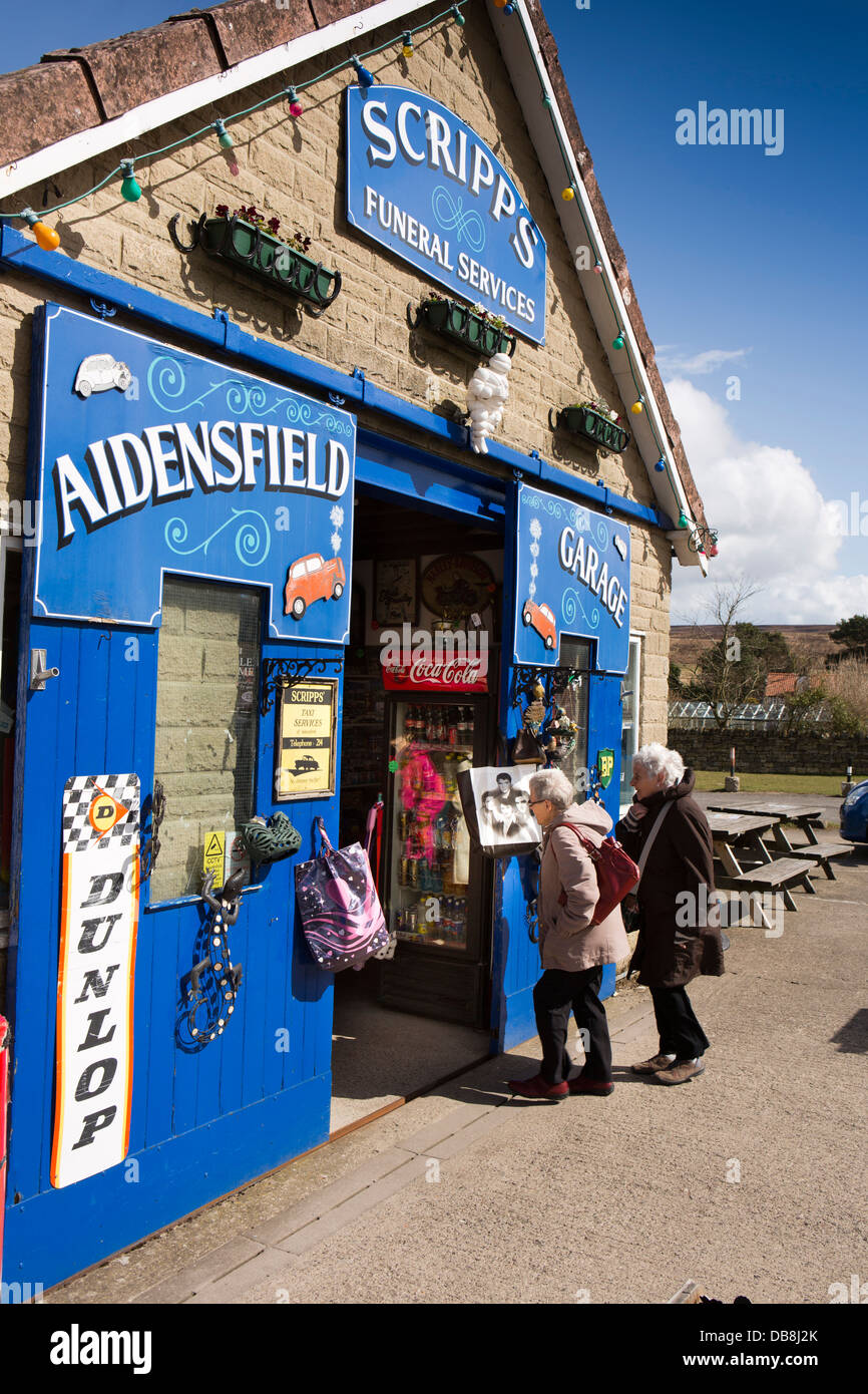 UK, England, Yorkshire, Goathland, visitors at Aidensfield Garage ...