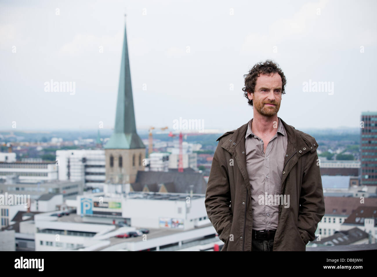Actors Joerg Hartmann (as Detective Peter Faber) stands on a roof ...