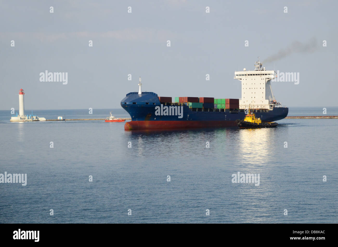 Container ship in a sea port and lighthouse Stock Photo - Alamy
