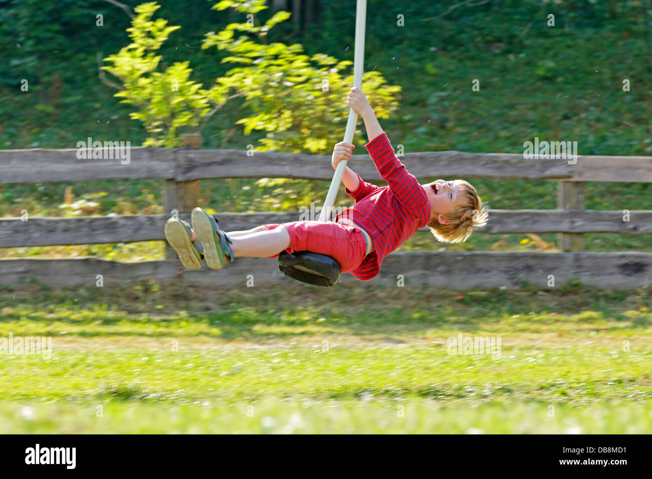 young boy riding playground ropeway Stock Photo - Alamy