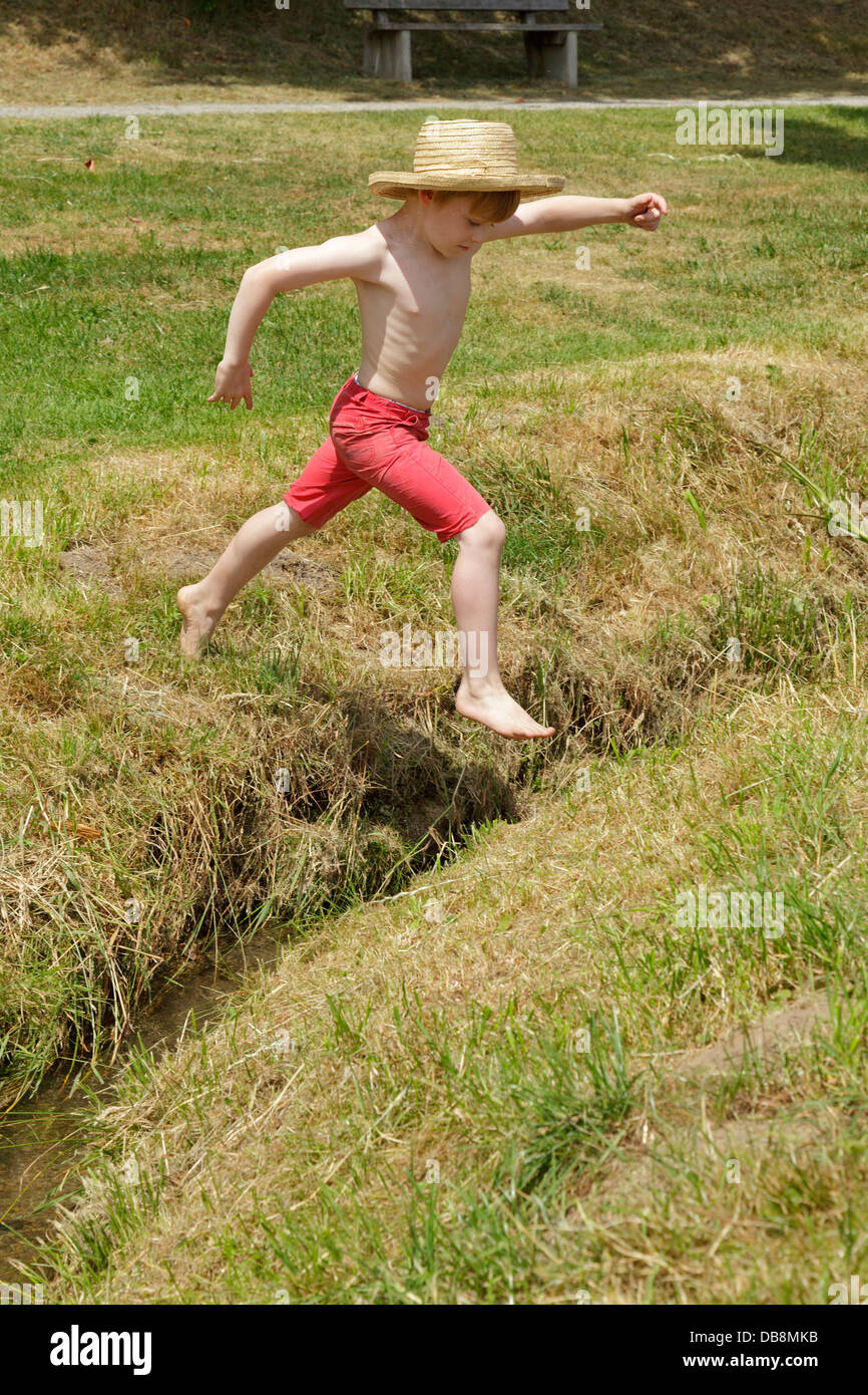 Boy Jumping Across Water Stock Photos & Boy Jumping Across Water Stock ...
