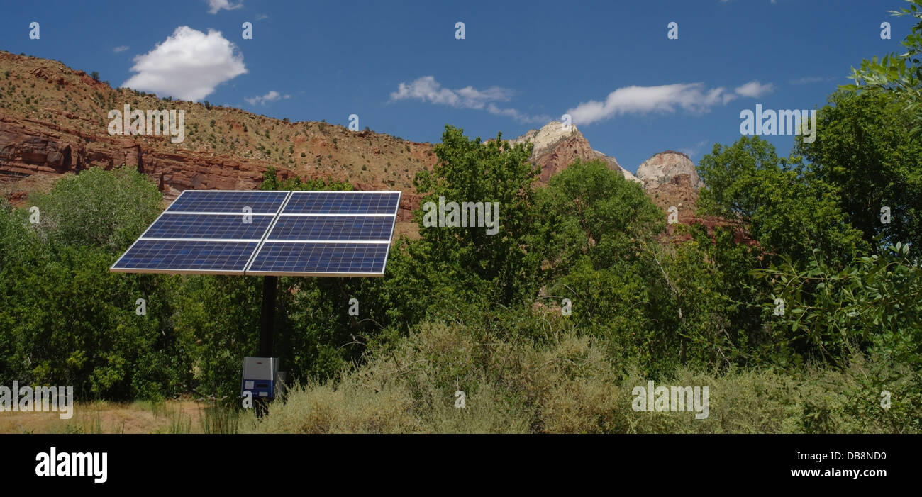Blue sky view solar panel rising green trees valley floor below brown ...