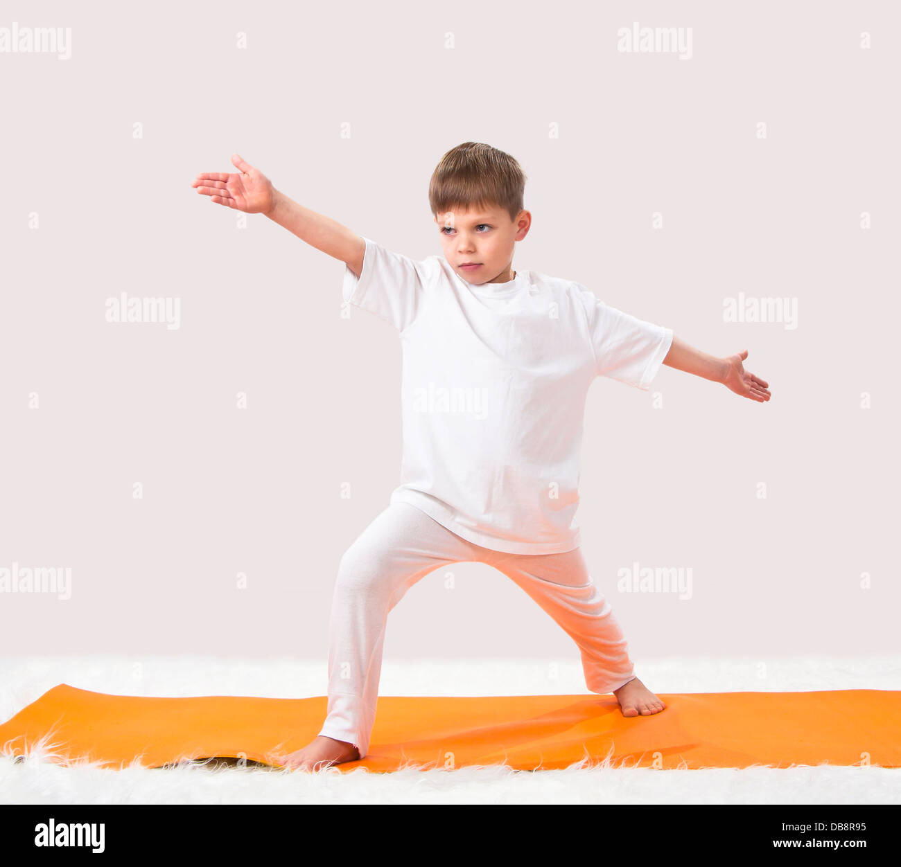 Children's yoga. The little boy does exercise Stock Photo - Alamy