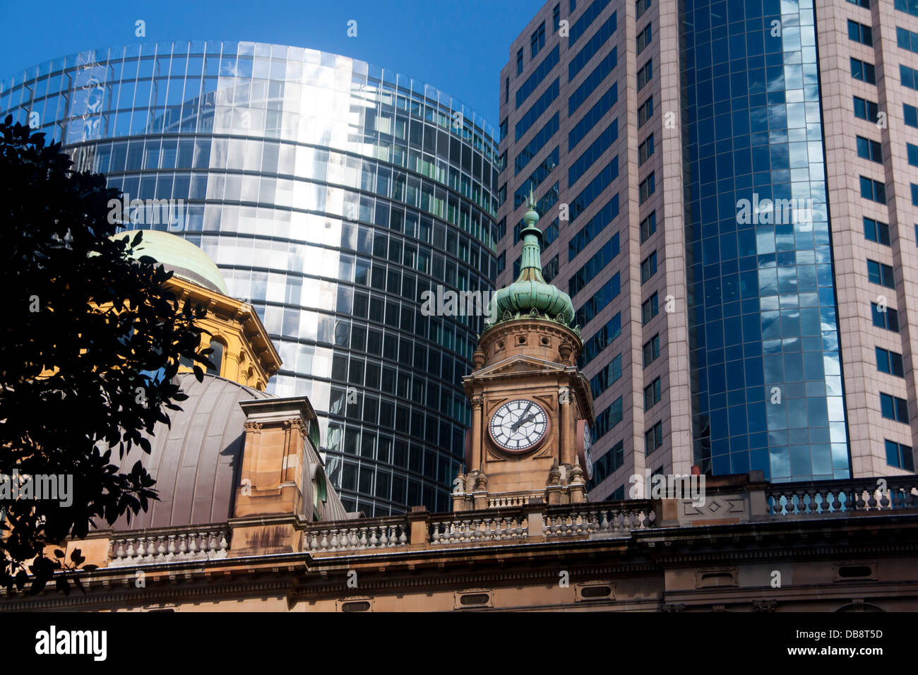 Clock tower of Lands Department building with glass fronted skyscraper ...