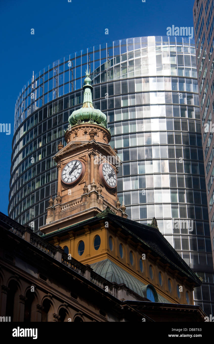Clock tower of Lands Department building with glass fronted skyscraper ...