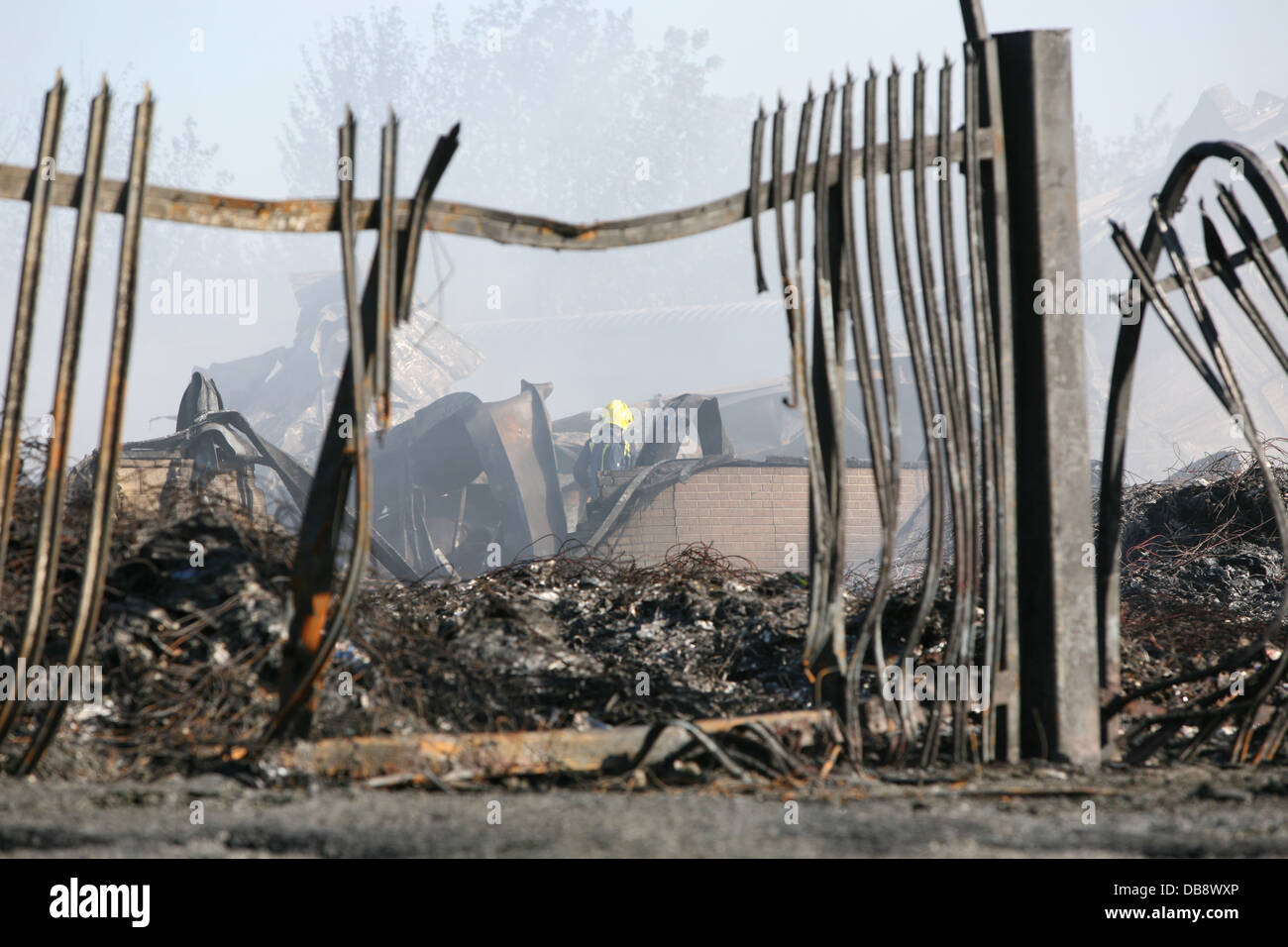 firefighters inspect a building that has been destroyed by fire Stock ...