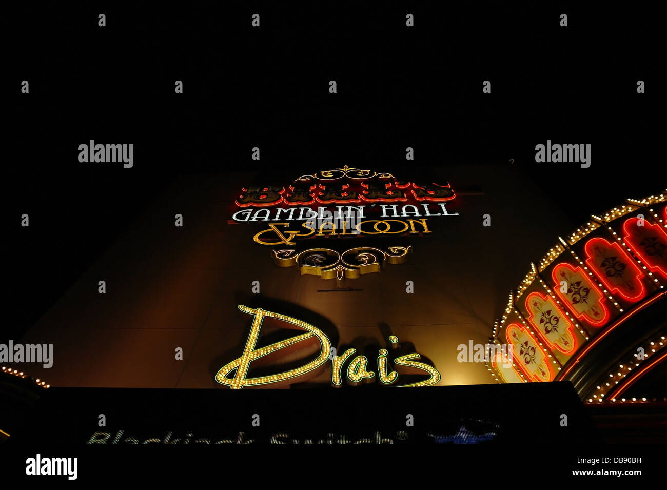 Night view, to the side of the entrance marquee, yellow Drai's sign ...