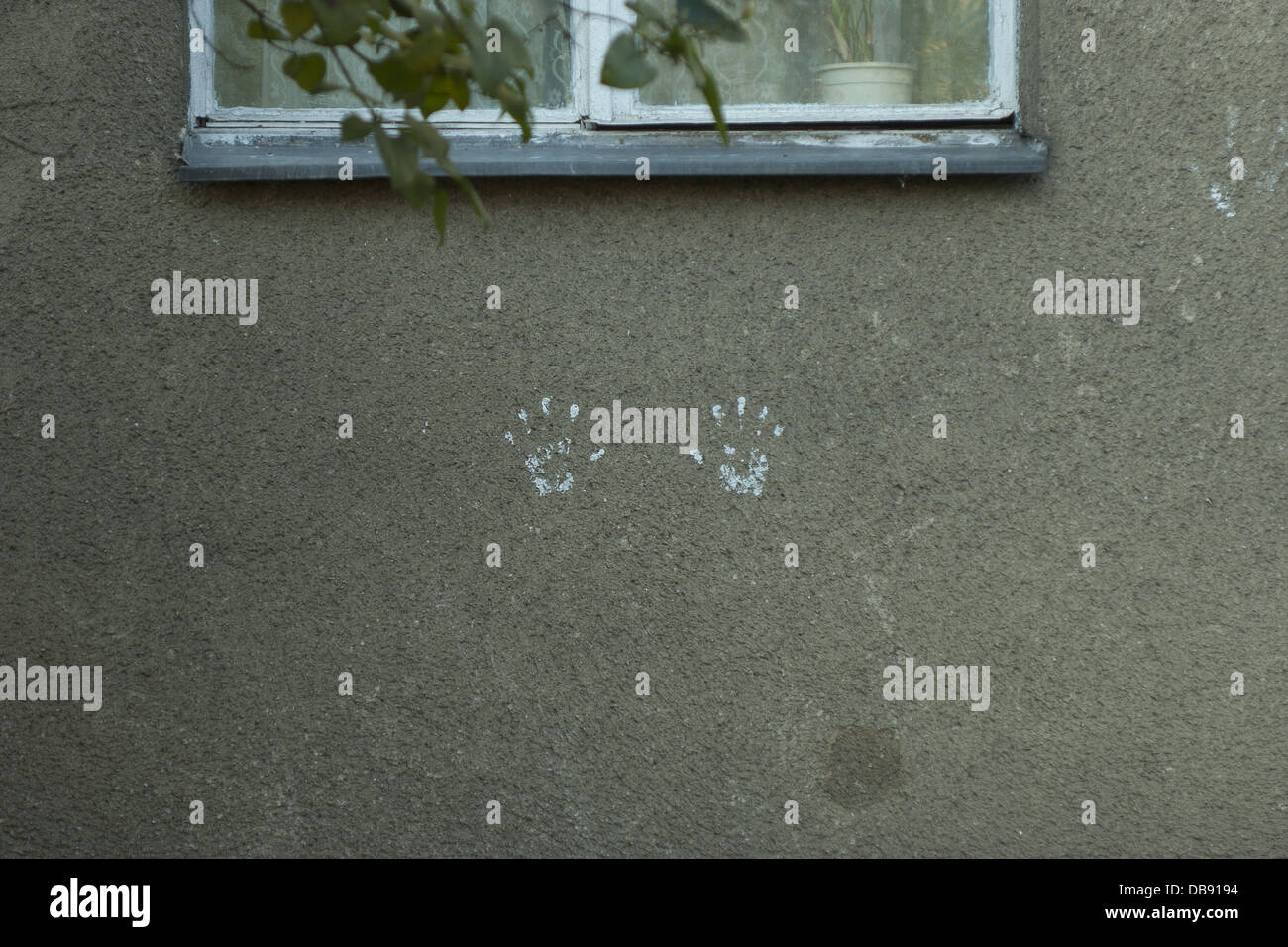 White handprint on the gray wall below the window Stock Photo - Alamy