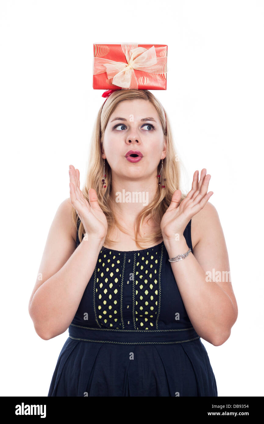 Surprised woman with gift box on the head, isolated on white background ...
