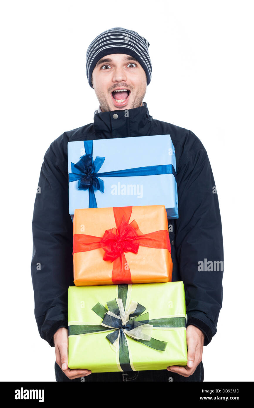 Ecstatic man in winter jacket holding many presents, isolated on white ...
