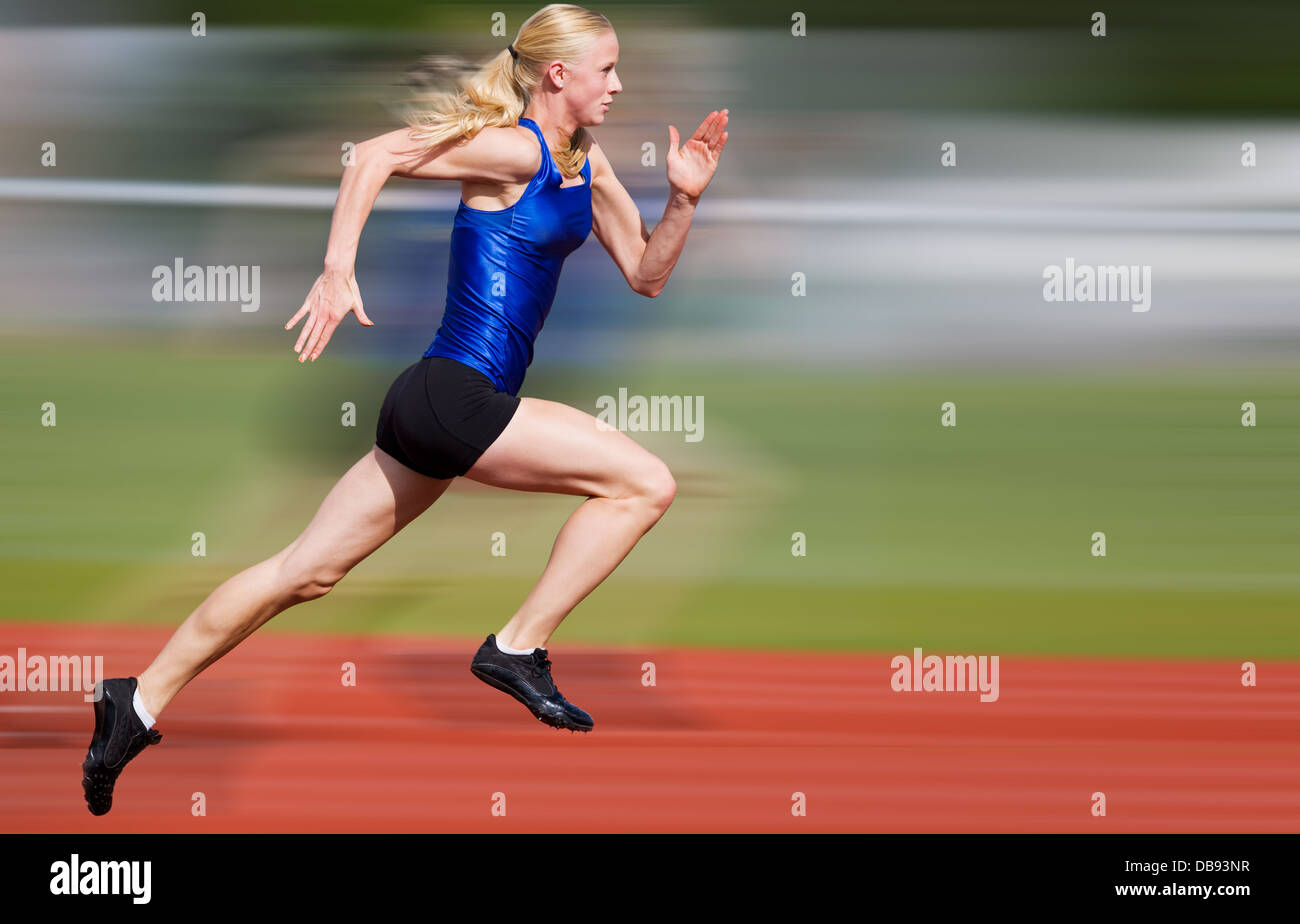 Young athlete running down the track with motion blur added Stock Photo ...