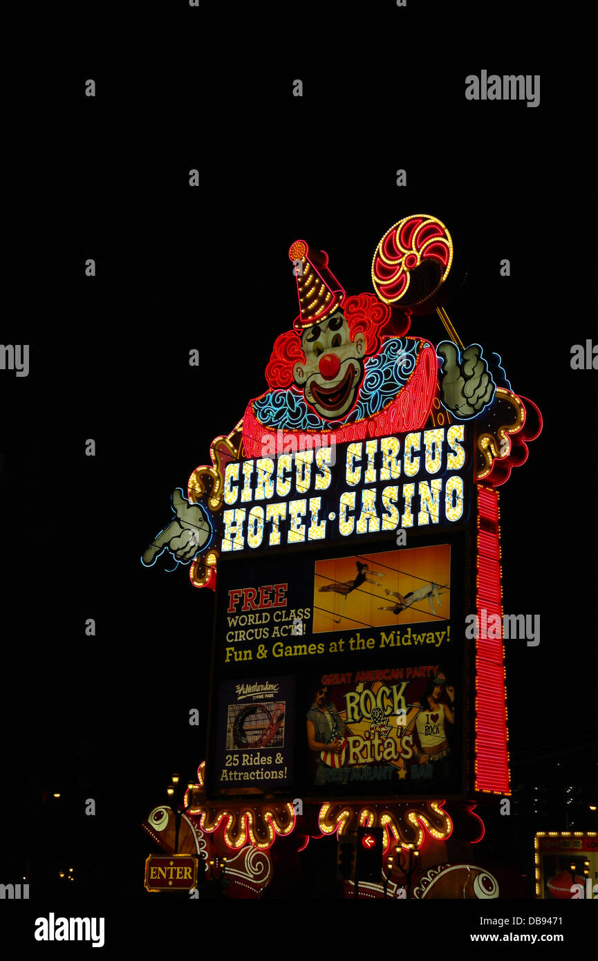 Black sky night neon red blue colours smiling face electric sign marque ...