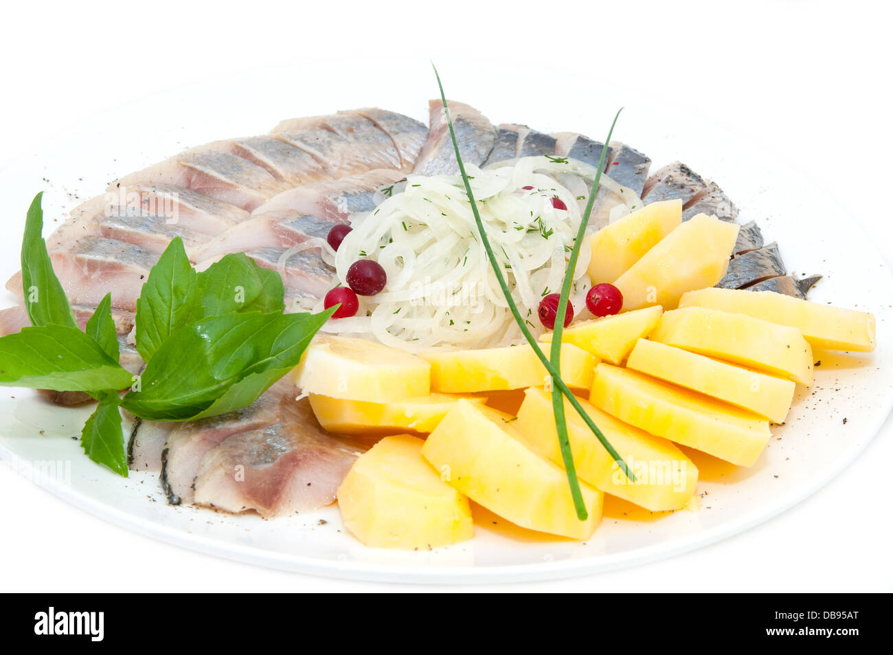 a plate of herring on a white background Stock Photo - Alamy