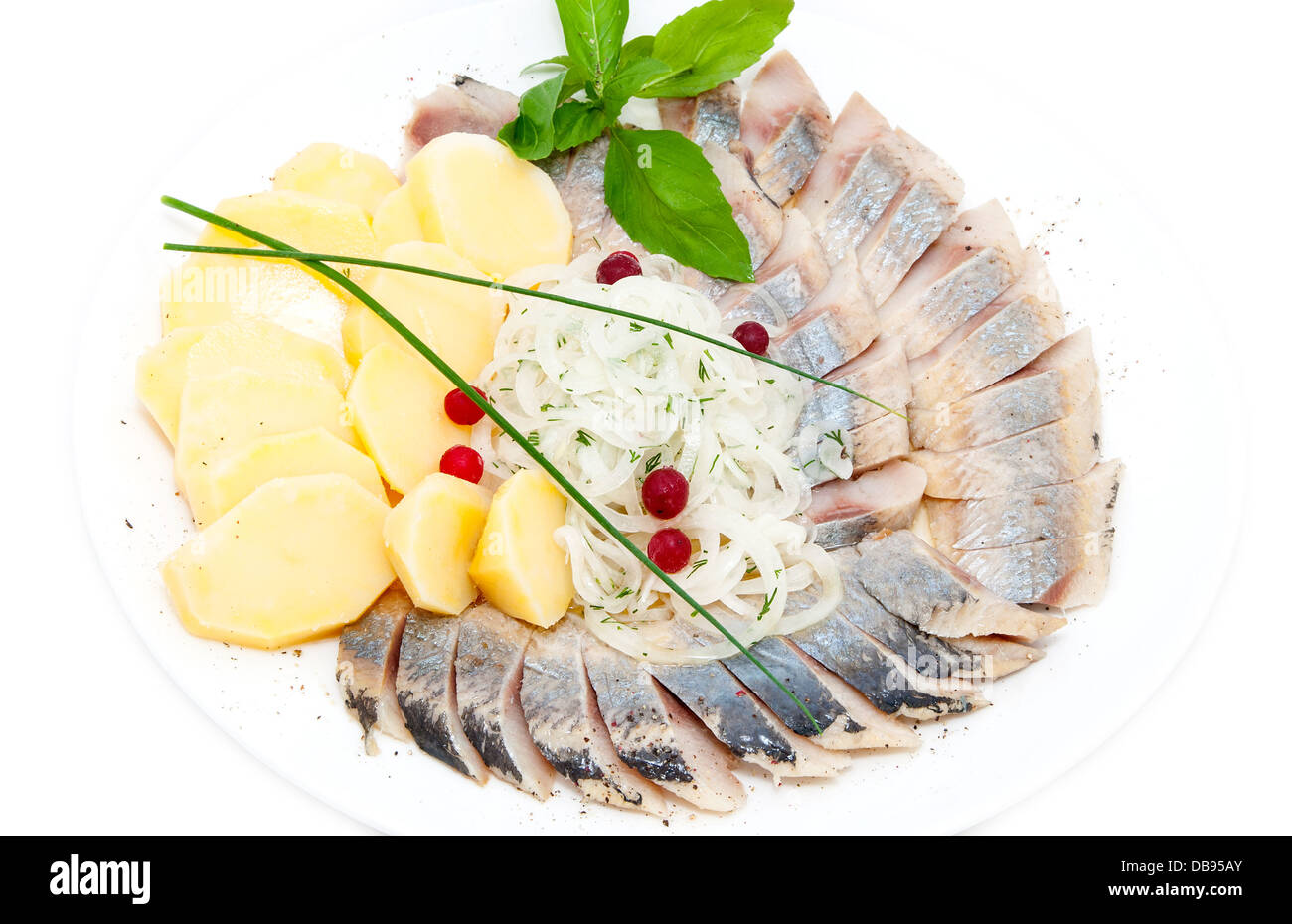 a plate of herring on a white background Stock Photo - Alamy