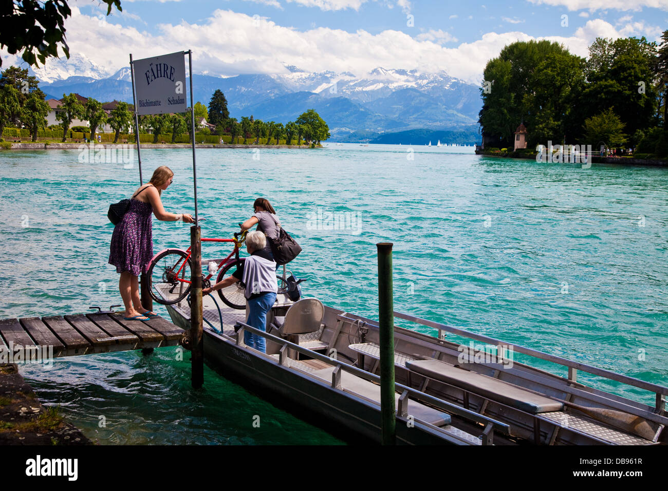People taking the ferry over the River Aare in the Swiss town of Thun ...