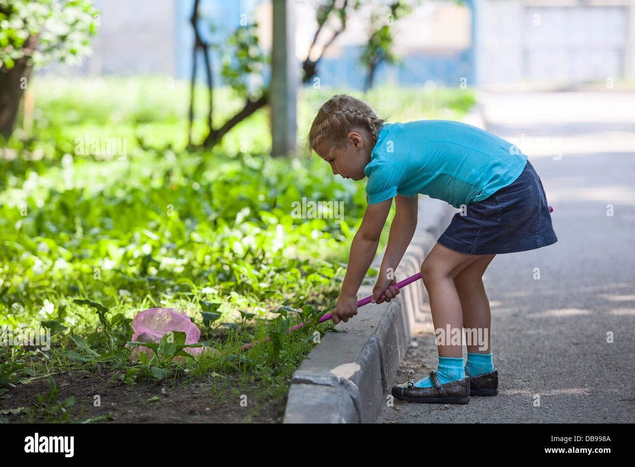 Preschooler girl catching butterfly in the meadow Stock Photo - Alamy