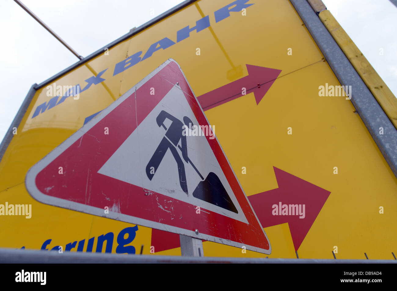 A traffic sign indicating construction work is visible in front of a ...