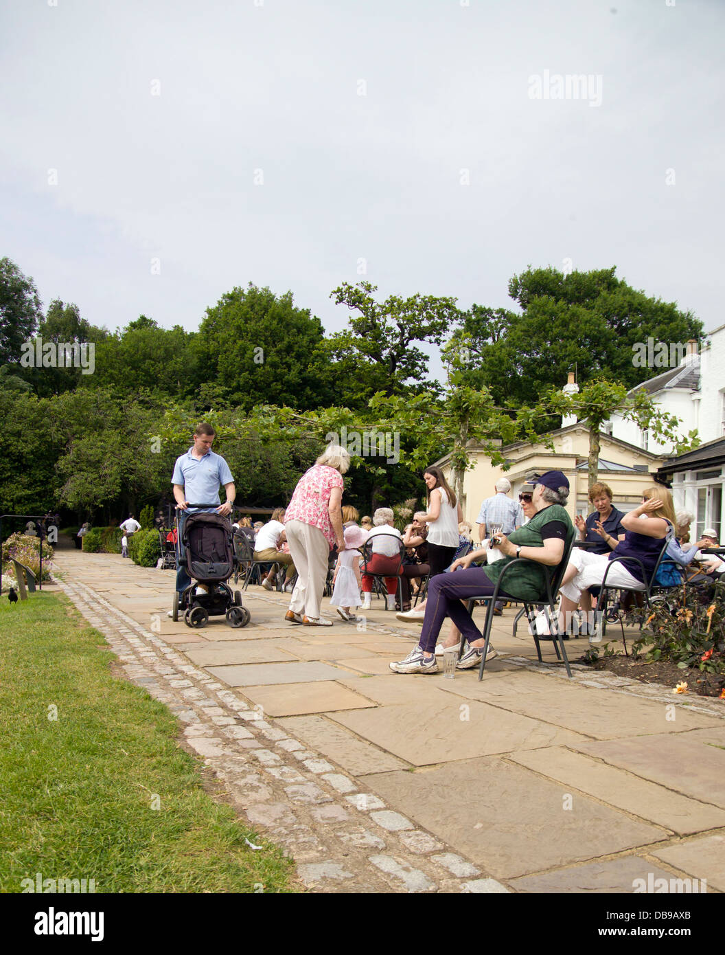 outdoor cafe families seated eating drinking enjoying the summer day in ...