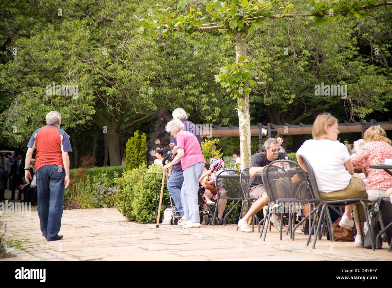 outdoor cafe families seated eating drinking enjoying the summer day in ...