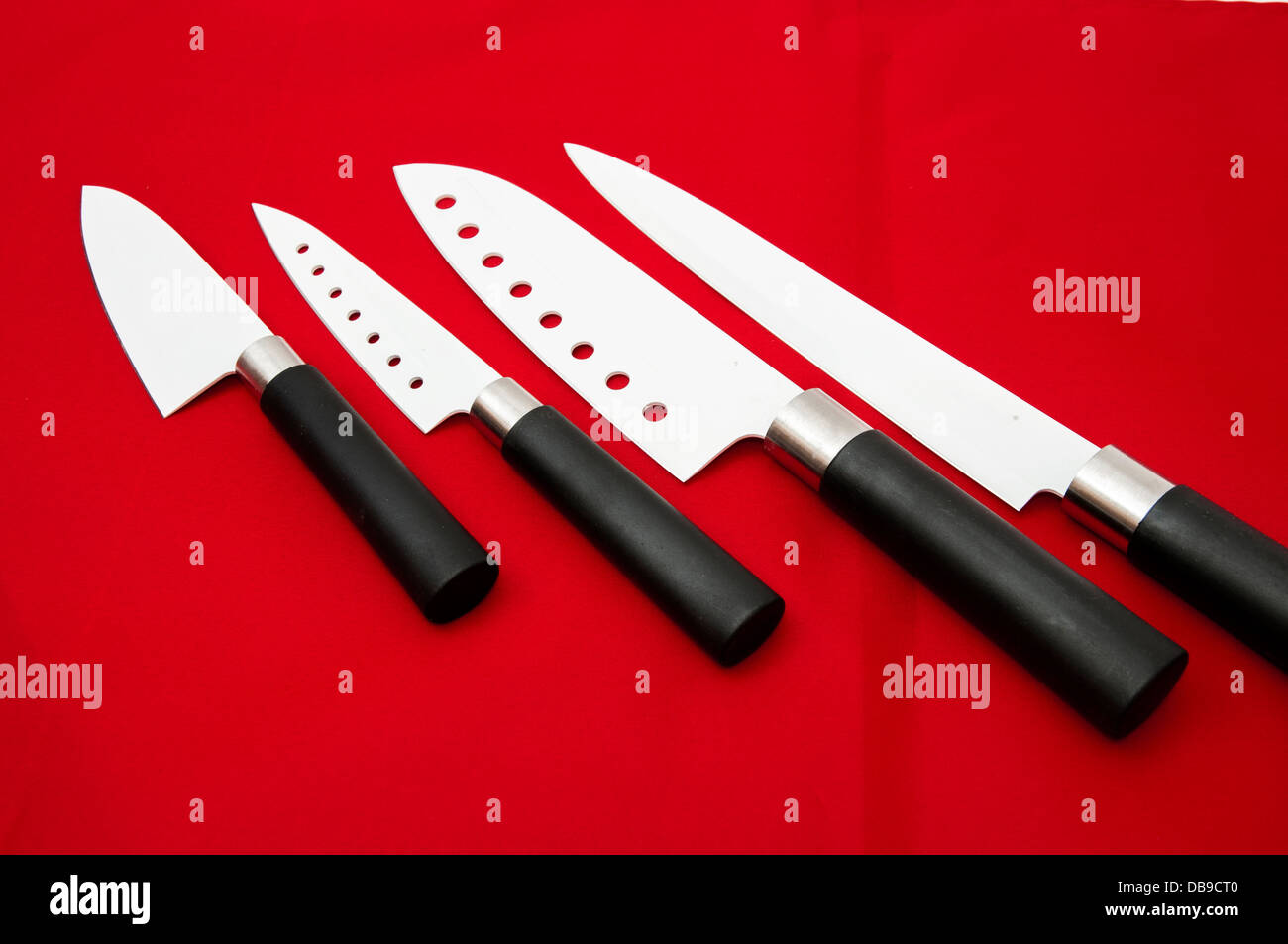 cutting knives sharp white on a red background Stock Photo - Alamy