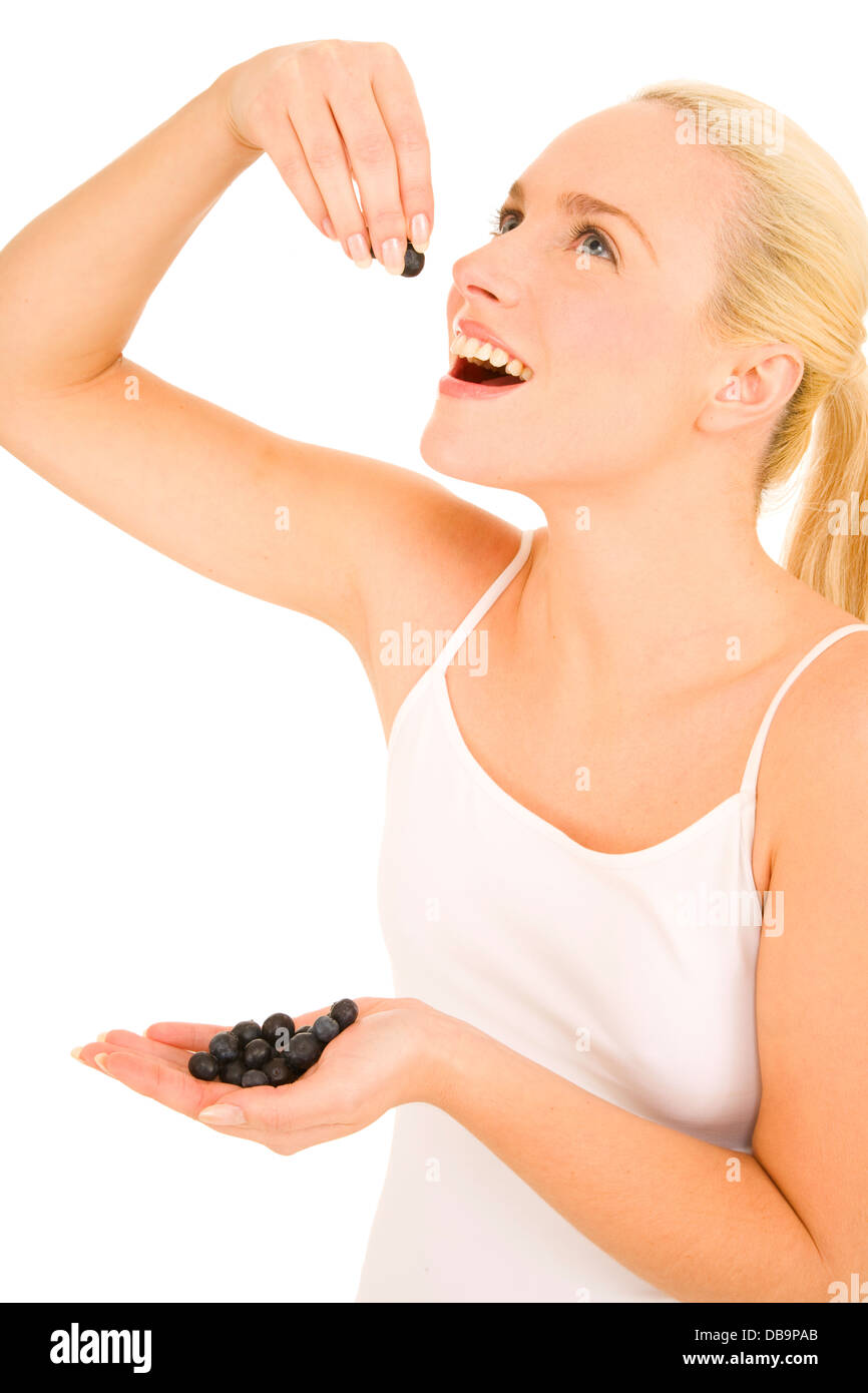 Woman eating blueberries Stock Photo - Alamy
