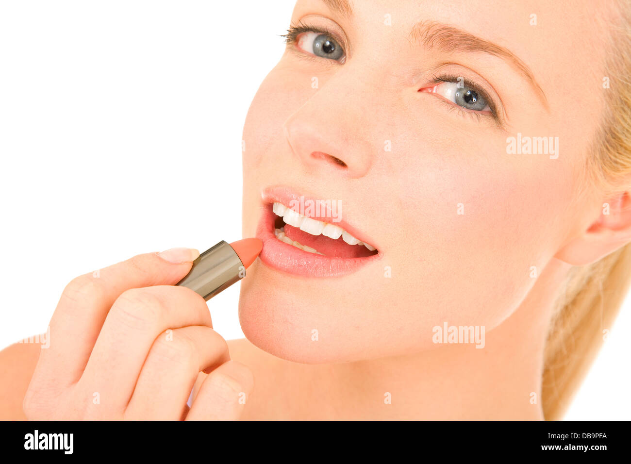 Woman applying lipstick Stock Photo - Alamy