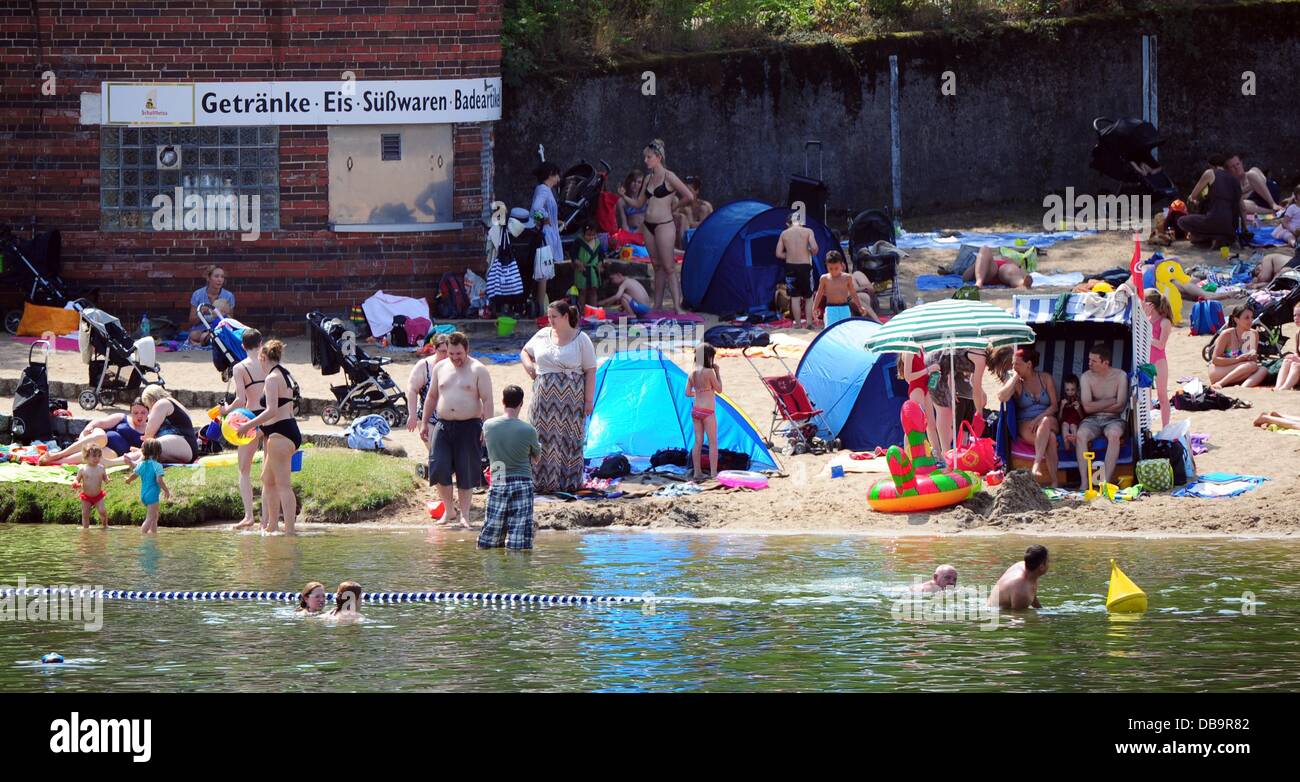 People sit on the beach at Ploetzensee Lake in Berlin, Germany, 26 July ...