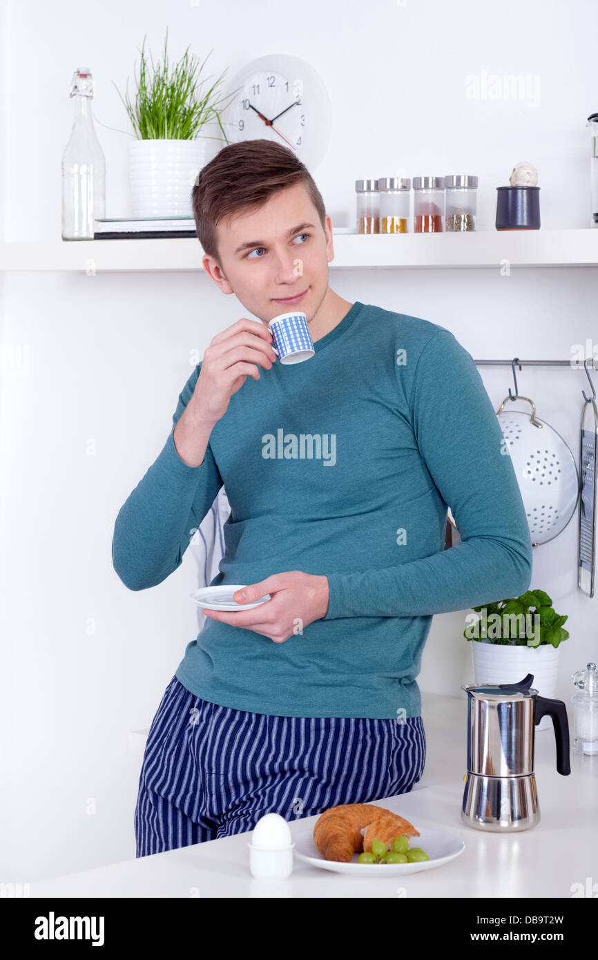 young man having breakfast in his modern kitchen Stock Photo - Alamy
