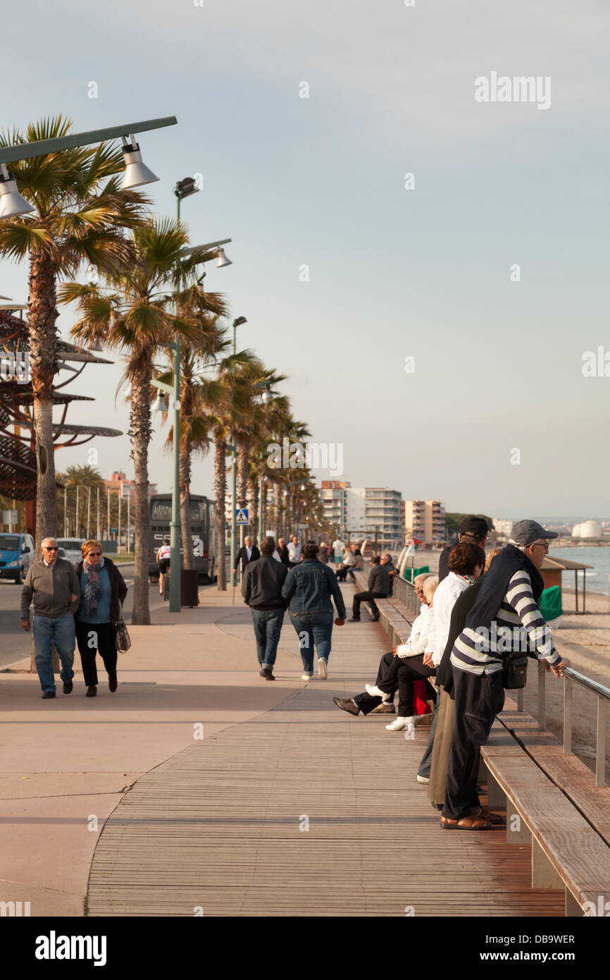 tourists on Palm tree promenade at La Pineda Stock Photo - Alamy