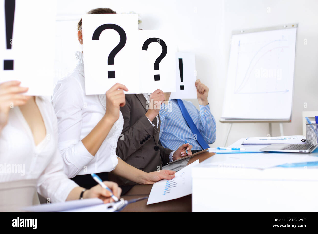 Businessmen in office with question marks Stock Photo - Alamy