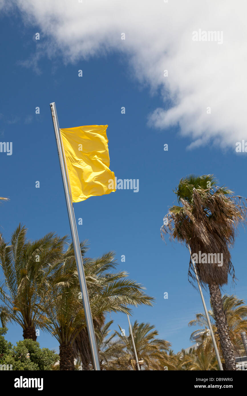 yellow beach warning flag Stock Photo - Alamy