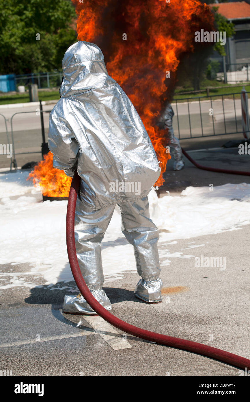 firefighter fighting fire Stock Photo - Alamy