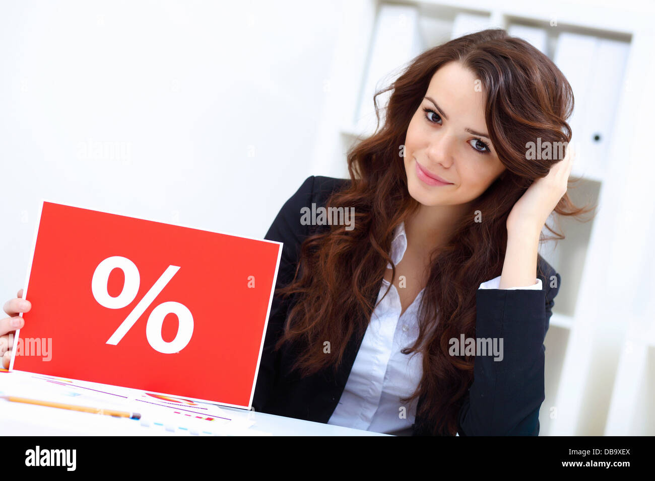 Young business woman with sale sign Stock Photo - Alamy