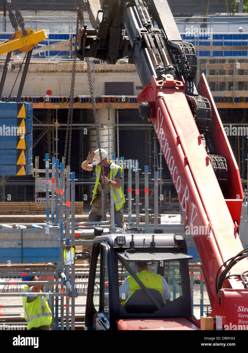 construction workers positioning something using teamwork and a huge ...