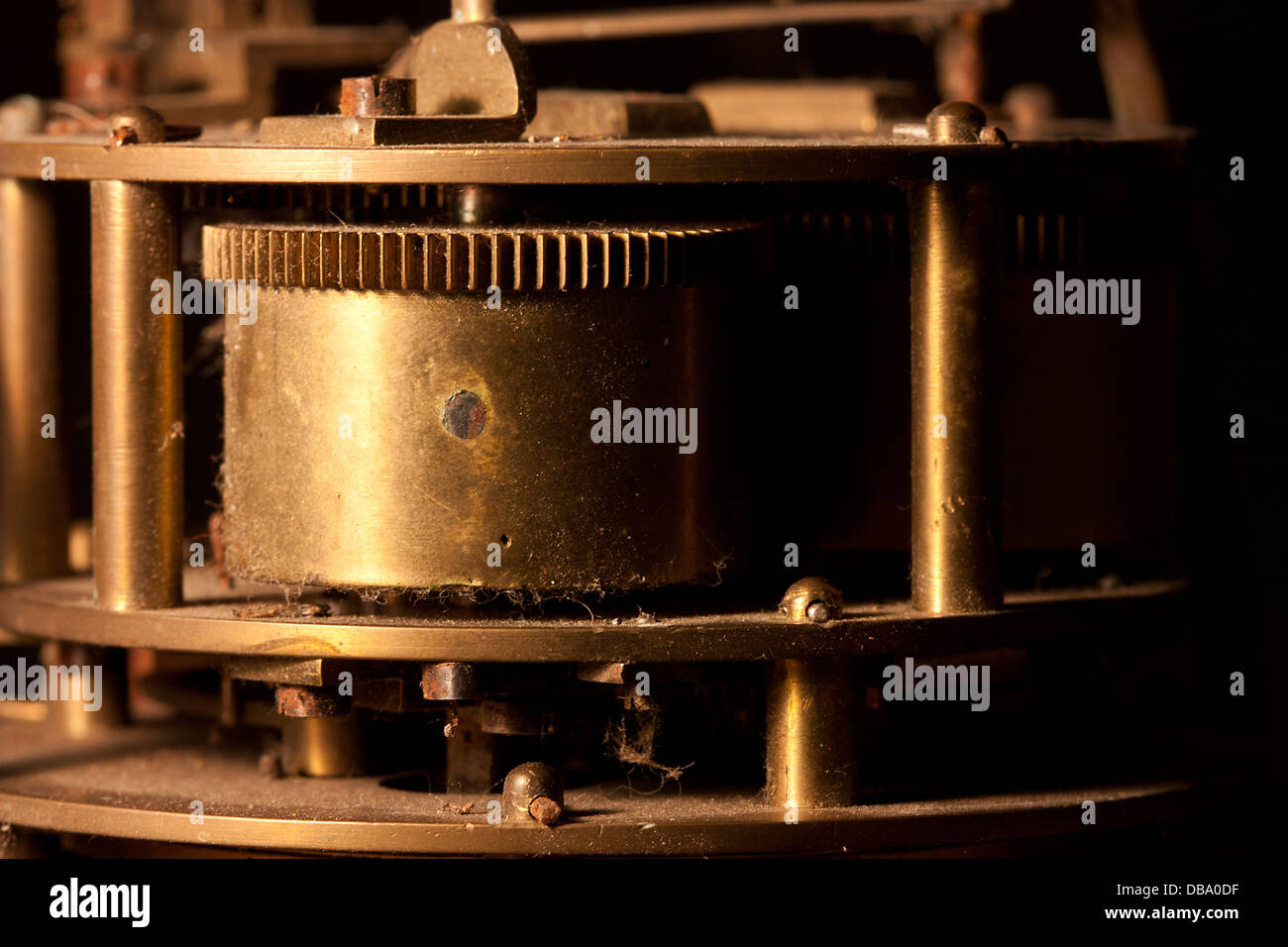 The inside of an old victorian clock showing the gears and cogs of the ...