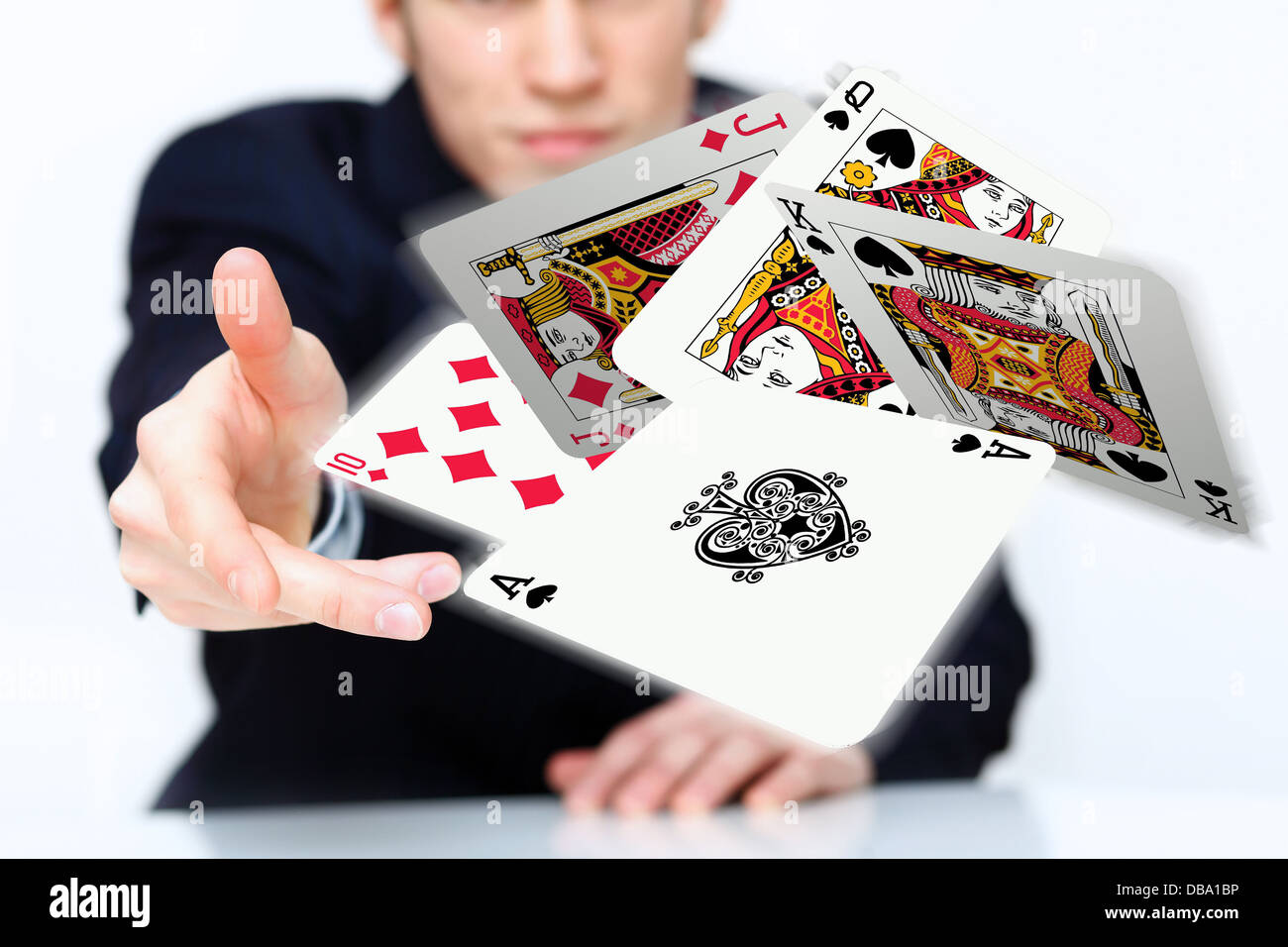 Young man showing poker cards Stock Photo - Alamy