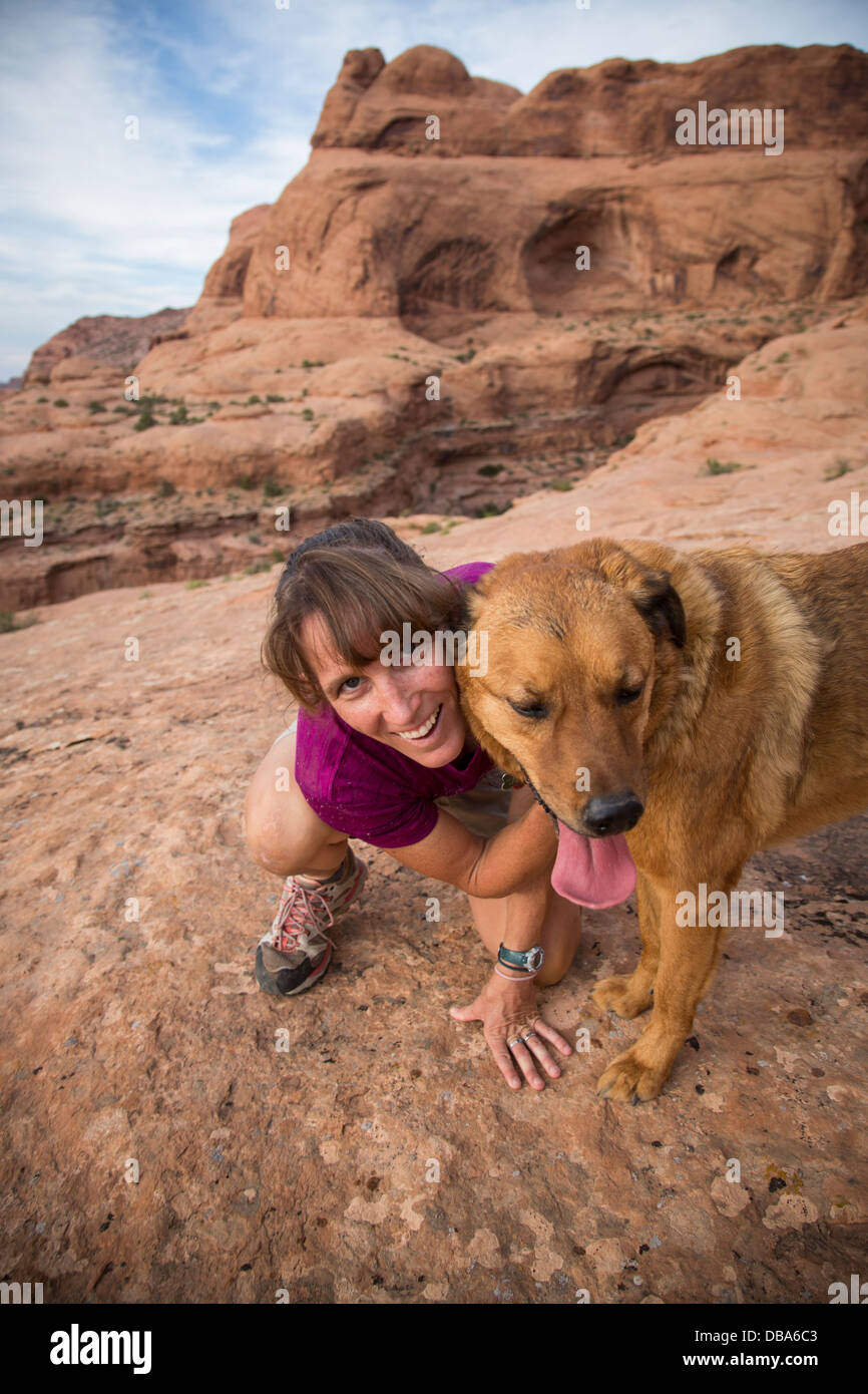 Danelle Ballengee posing with her dog near Moab, Utah Stock Photo - Alamy
