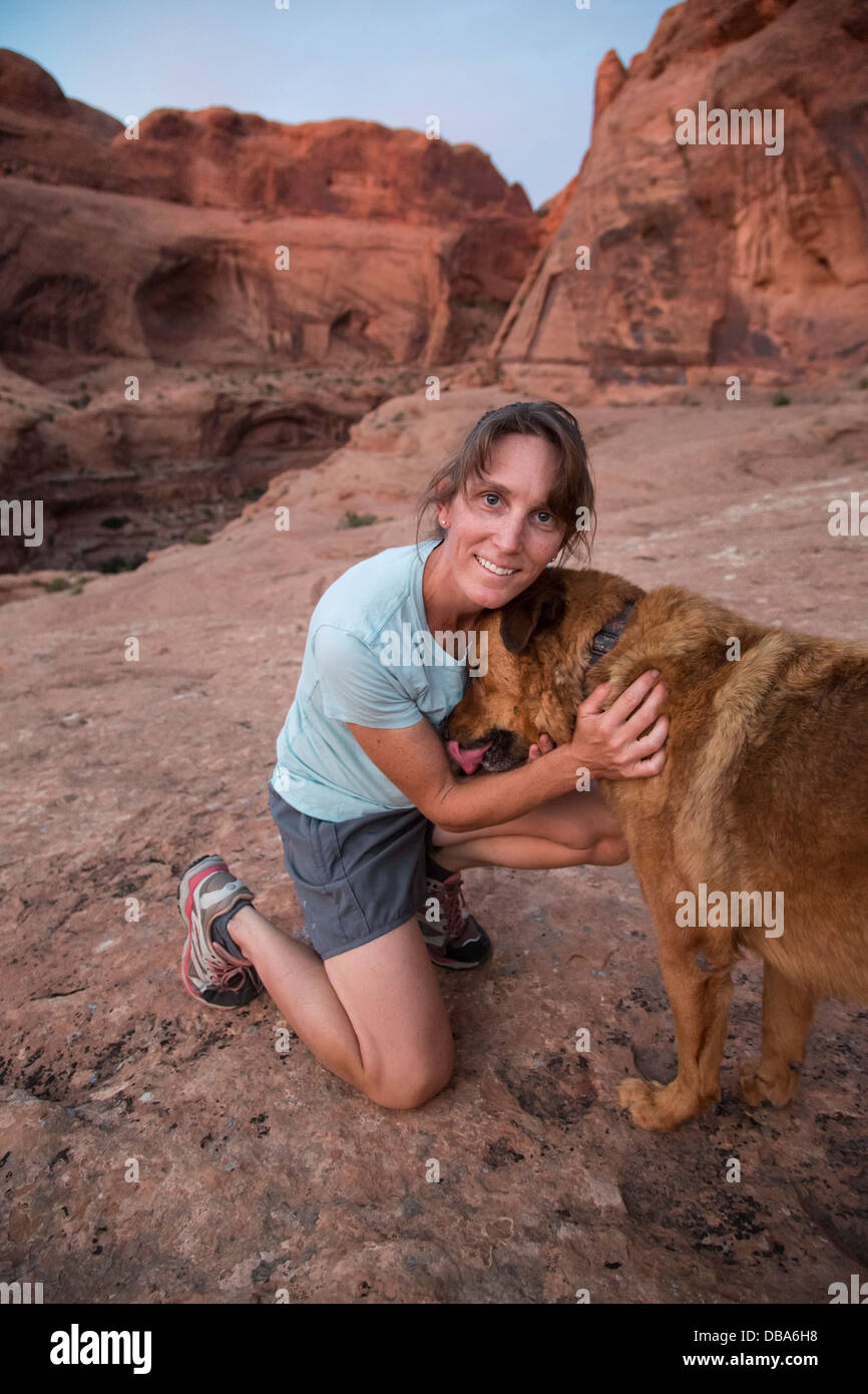 Danelle Ballengee posing with her dog near Moab, Utah Stock Photo - Alamy