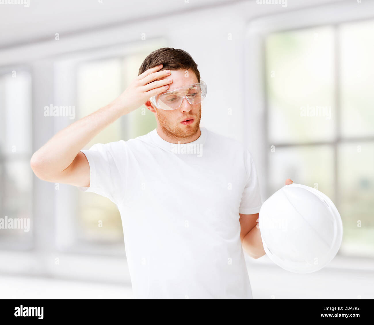male architect in safety glasses taking off helmet Stock Photo - Alamy
