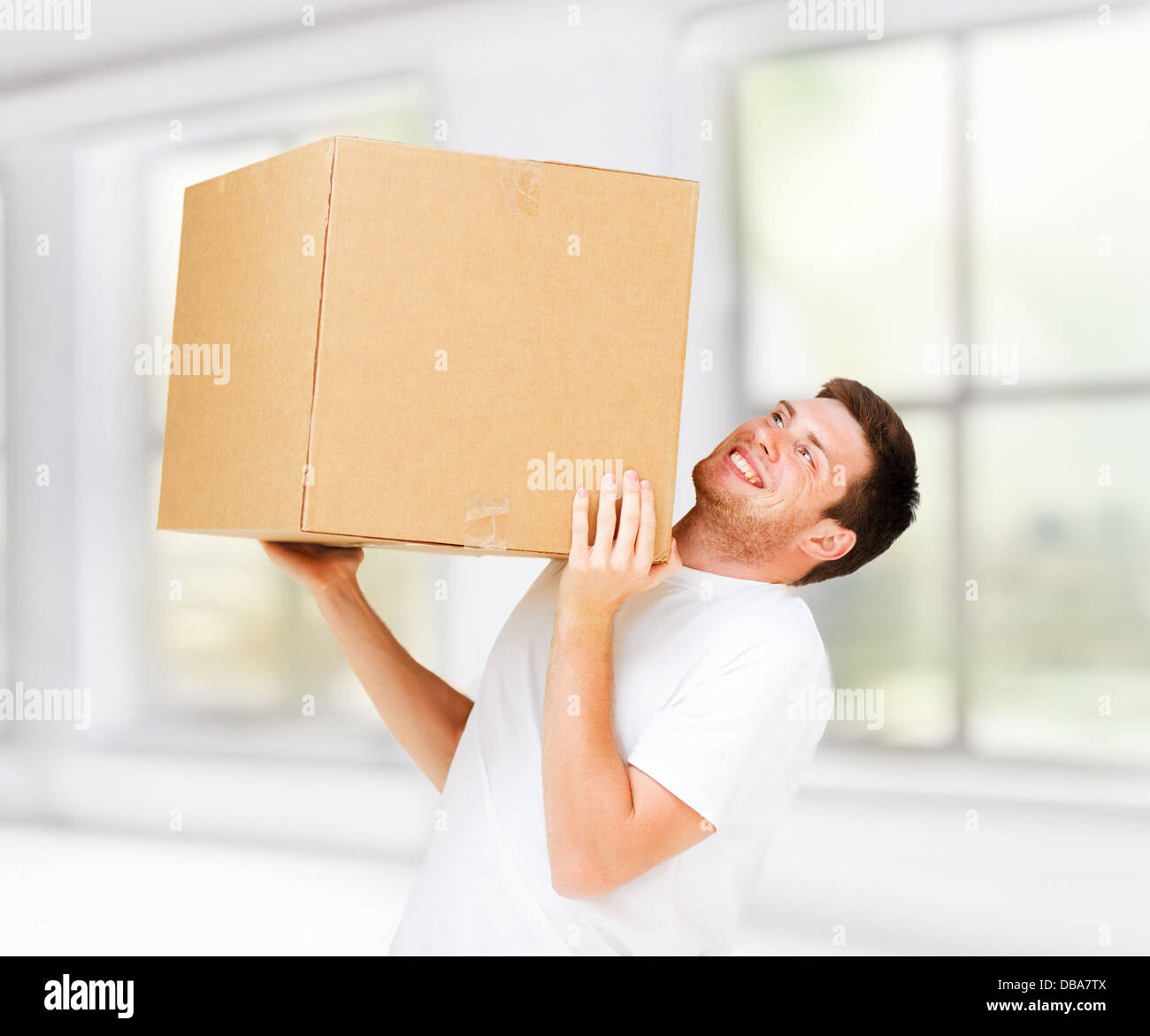 man carrying carton heavy box Stock Photo - Alamy