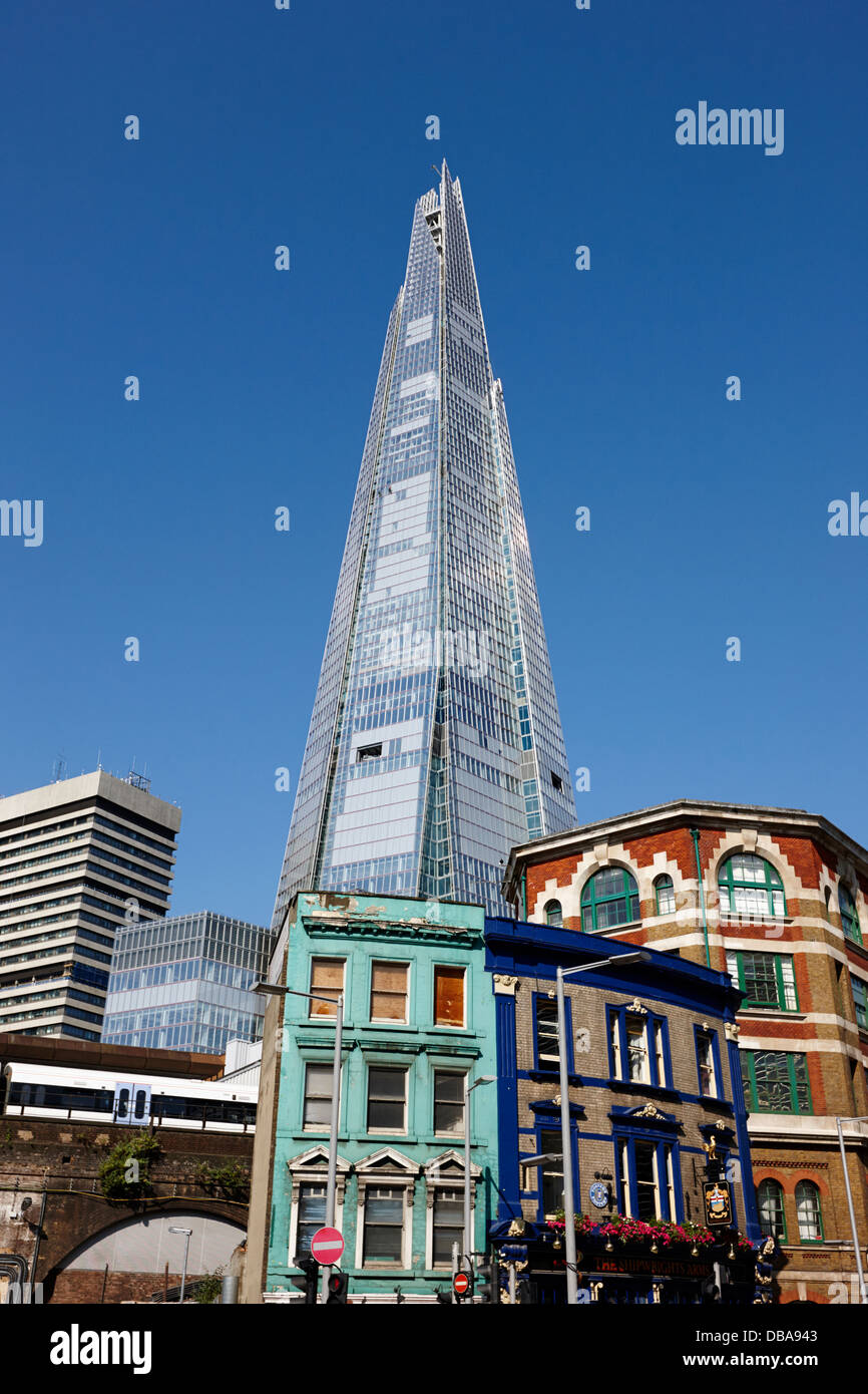 the shard building towering over local buildings in southwark London ...