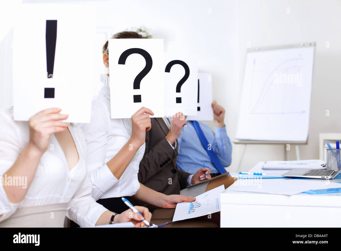 Businessmen in office with question marks Stock Photo - Alamy