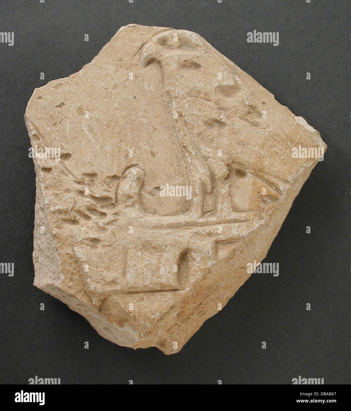 This relief fragment depicts a falcon perched on a standard, a common ...