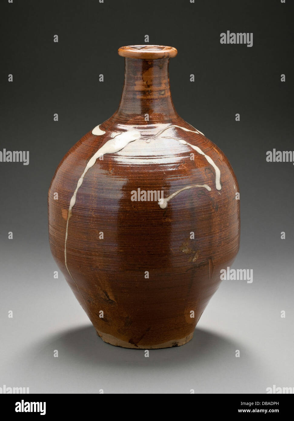 The tokkuri, a traditional Japanese sake bottle, is made from ceramic ...