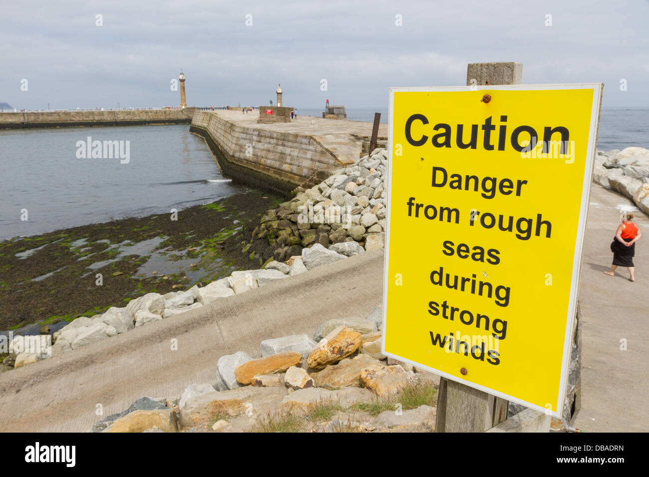 Caution sign about rough seas at Whitby Harbour Wall, North Yorkshire ...