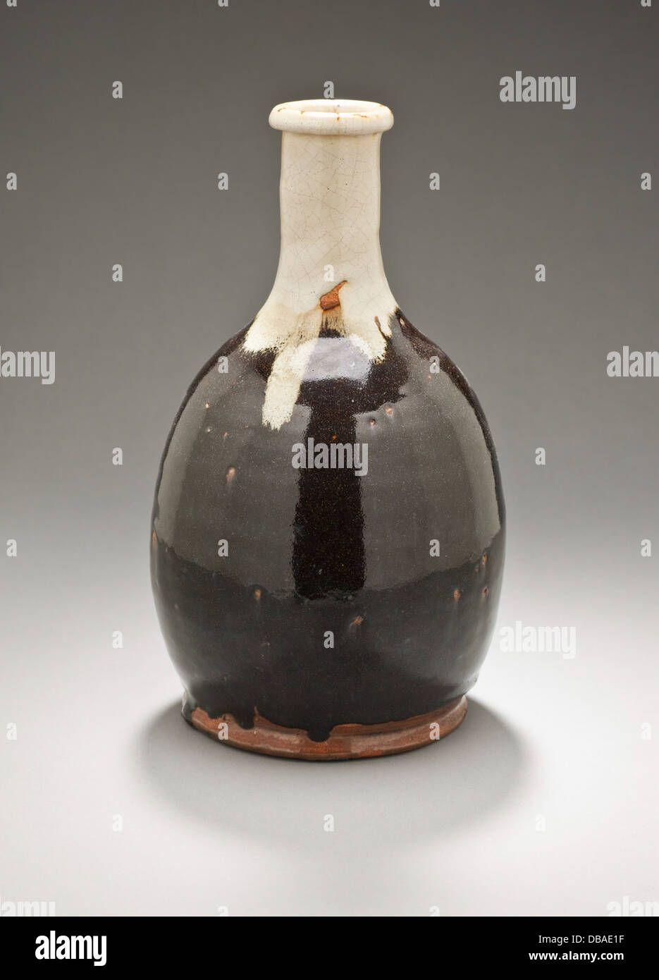 This sake bottle (tokkuri) is a traditional Japanese ceramic vessel ...