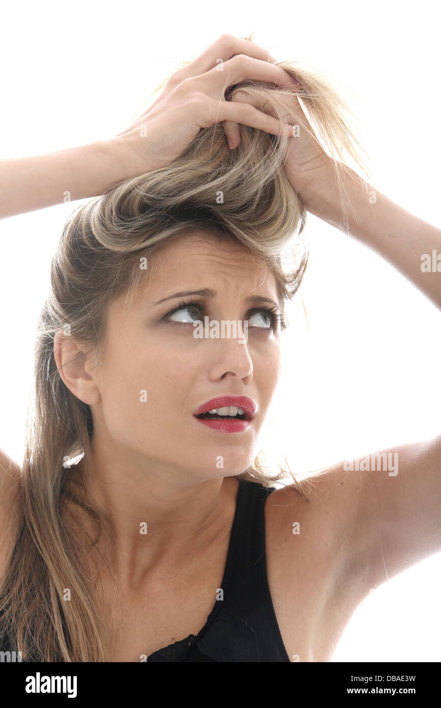 Model Released. Confused Young Woman Styling Hair Stock Photo - Alamy